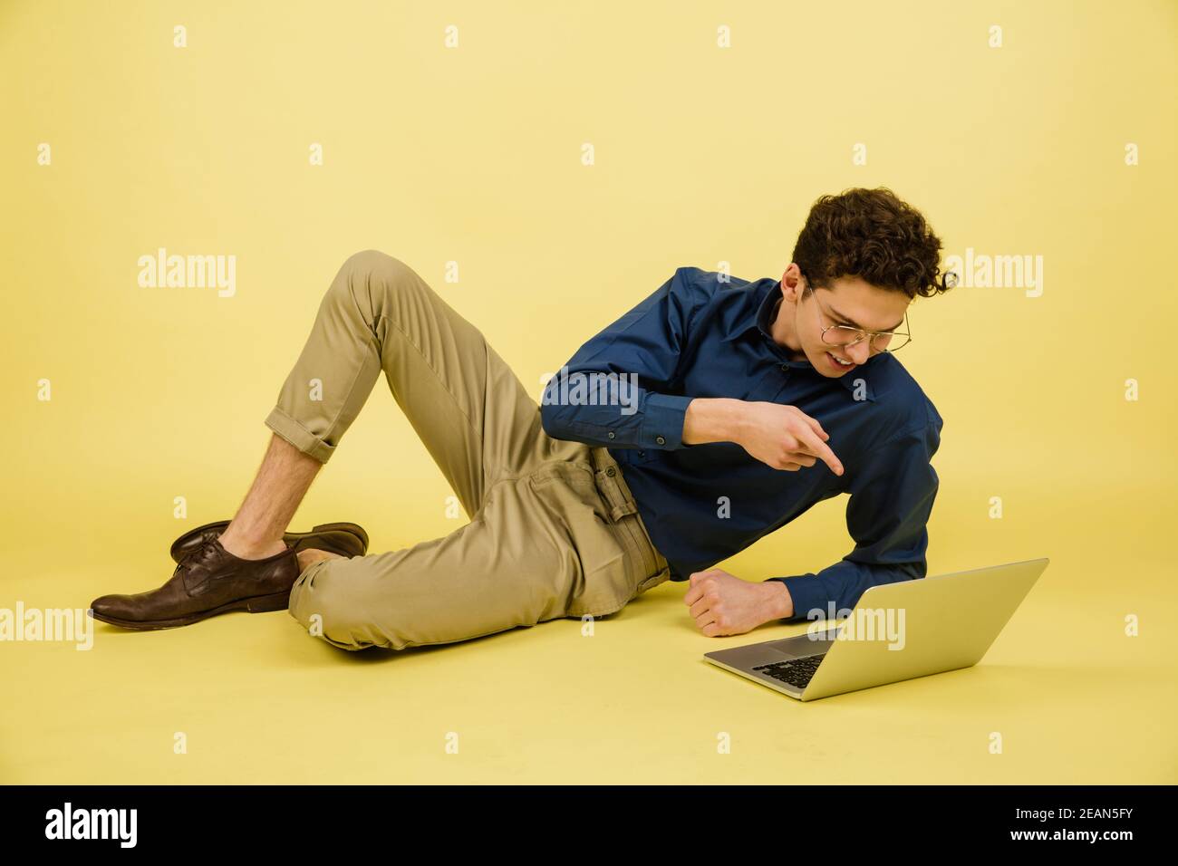 Pointing on screen. Caucasian handsome man's portrait isolated on ...