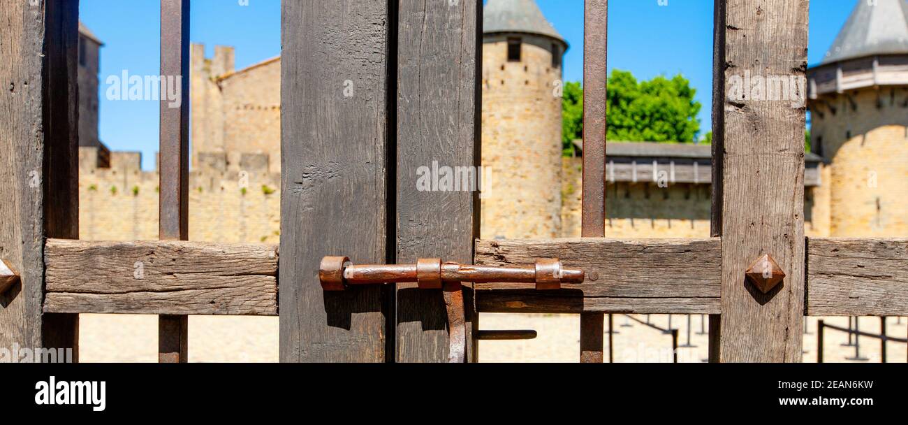 Old wooden gate closed to a large castle Stock Photo - Alamy
