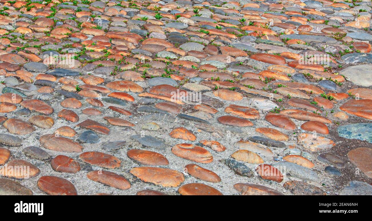 Cobbled, ancient city of stone road. Stone road texture Stock Photo - Alamy