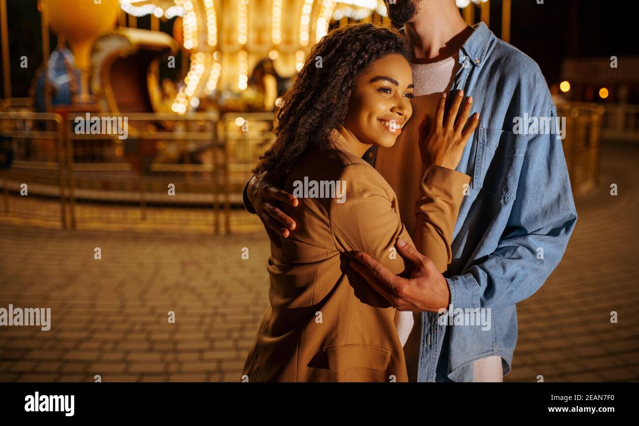 Couple walking in night amusement park, fairground Stock Photo - Alamy
