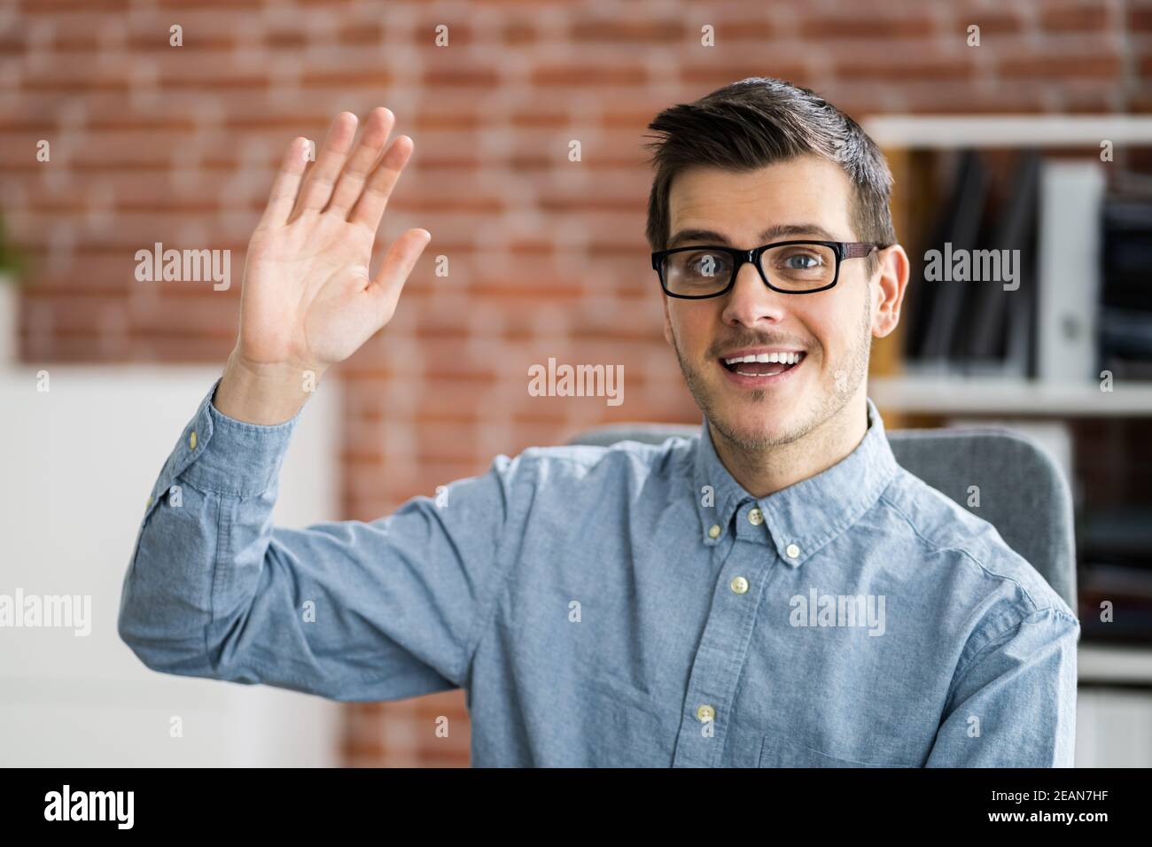 Man Raising Hand In Video Conference Call Stock Photo - Alamy
