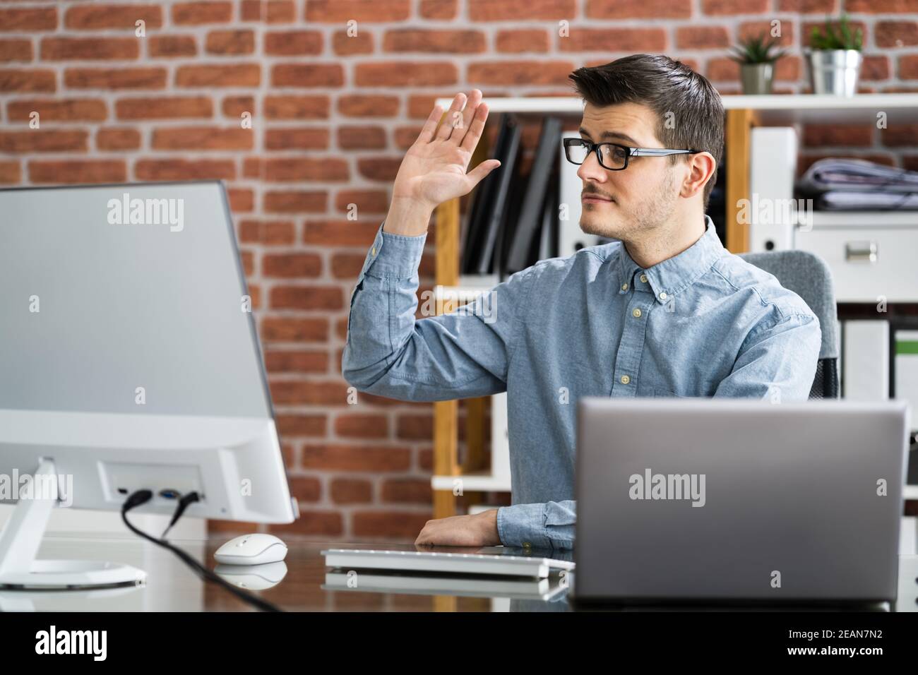 Man Raising Hand In Video Conference Call Stock Photo - Alamy