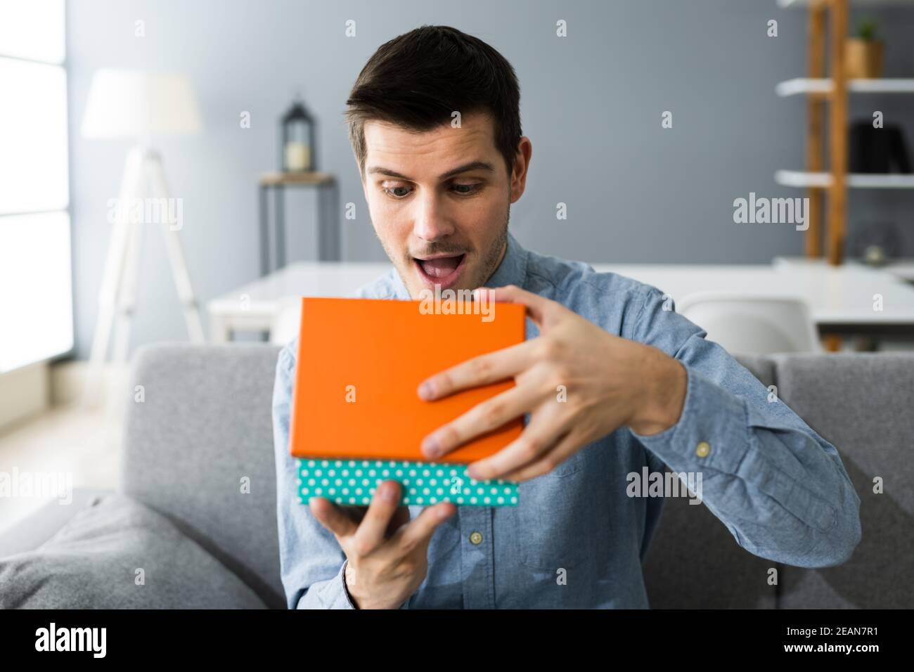 Happy Man Opening Gift Stock Photo - Alamy