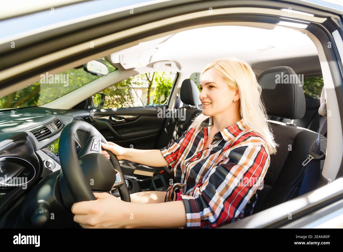 Young woman driving her car Stock Photo - Alamy