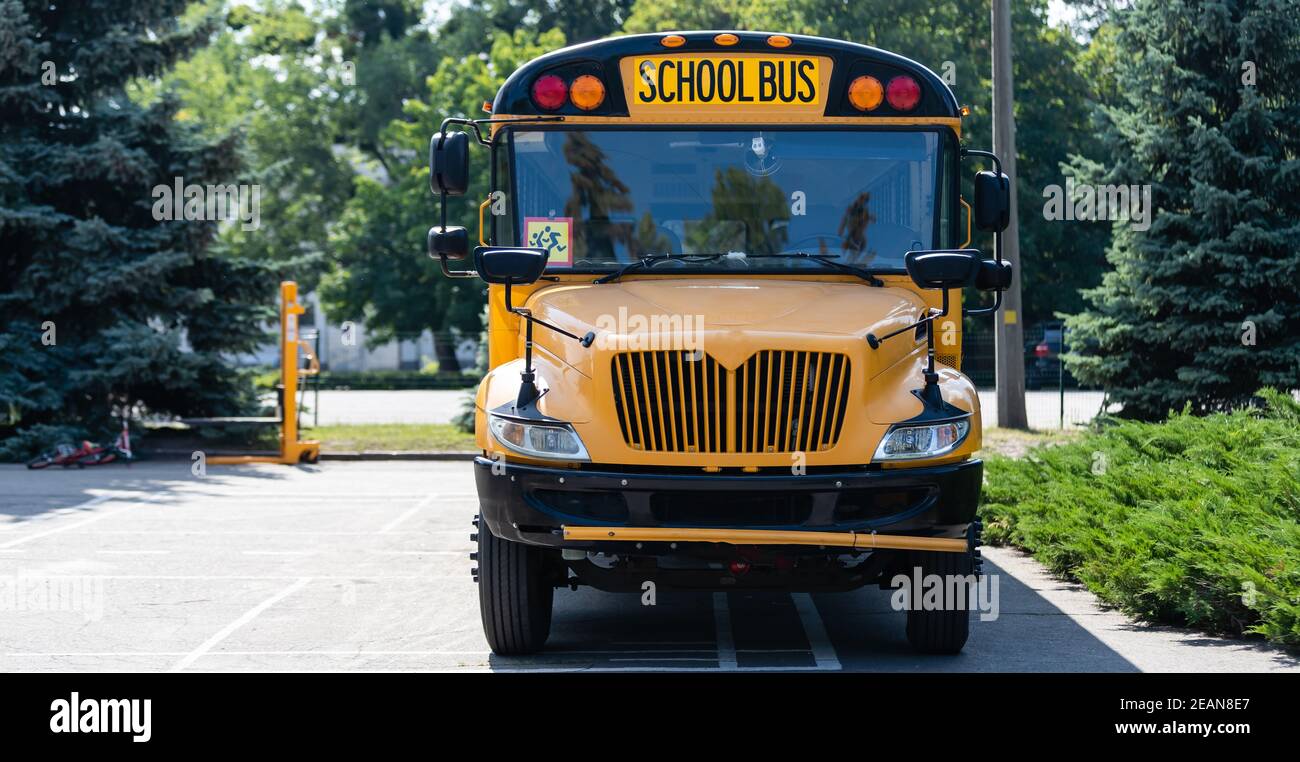 Yellow school bus on the street Stock Photo - Alamy