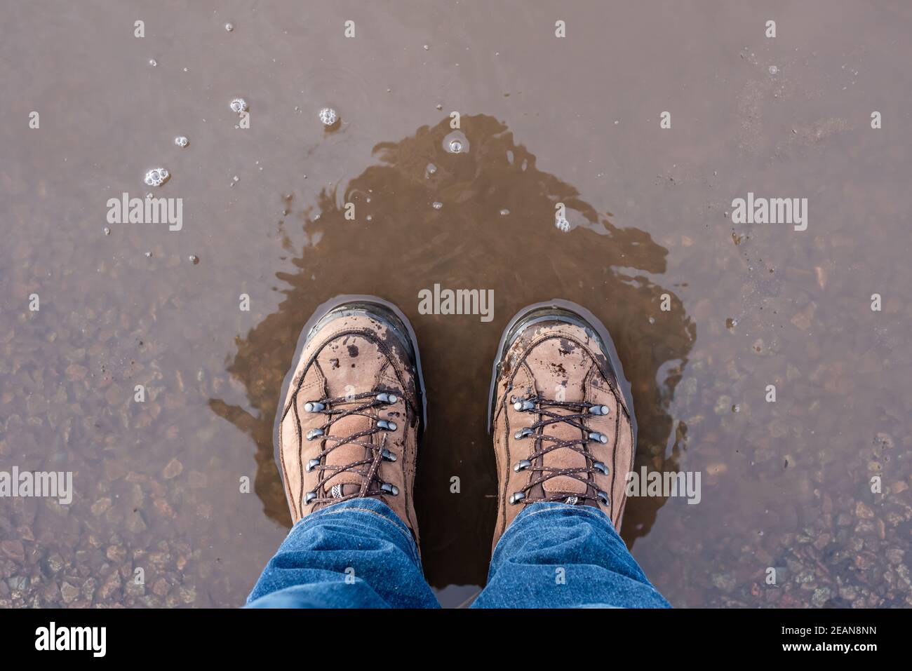 Overhead shot of feet wearing leather walking boots, standing in a ...