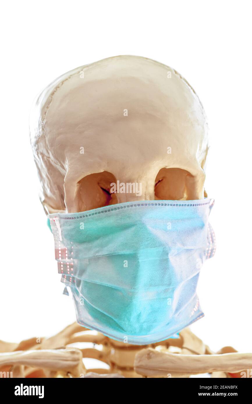 Human skull in simple thin medical mask for protection against viral ...