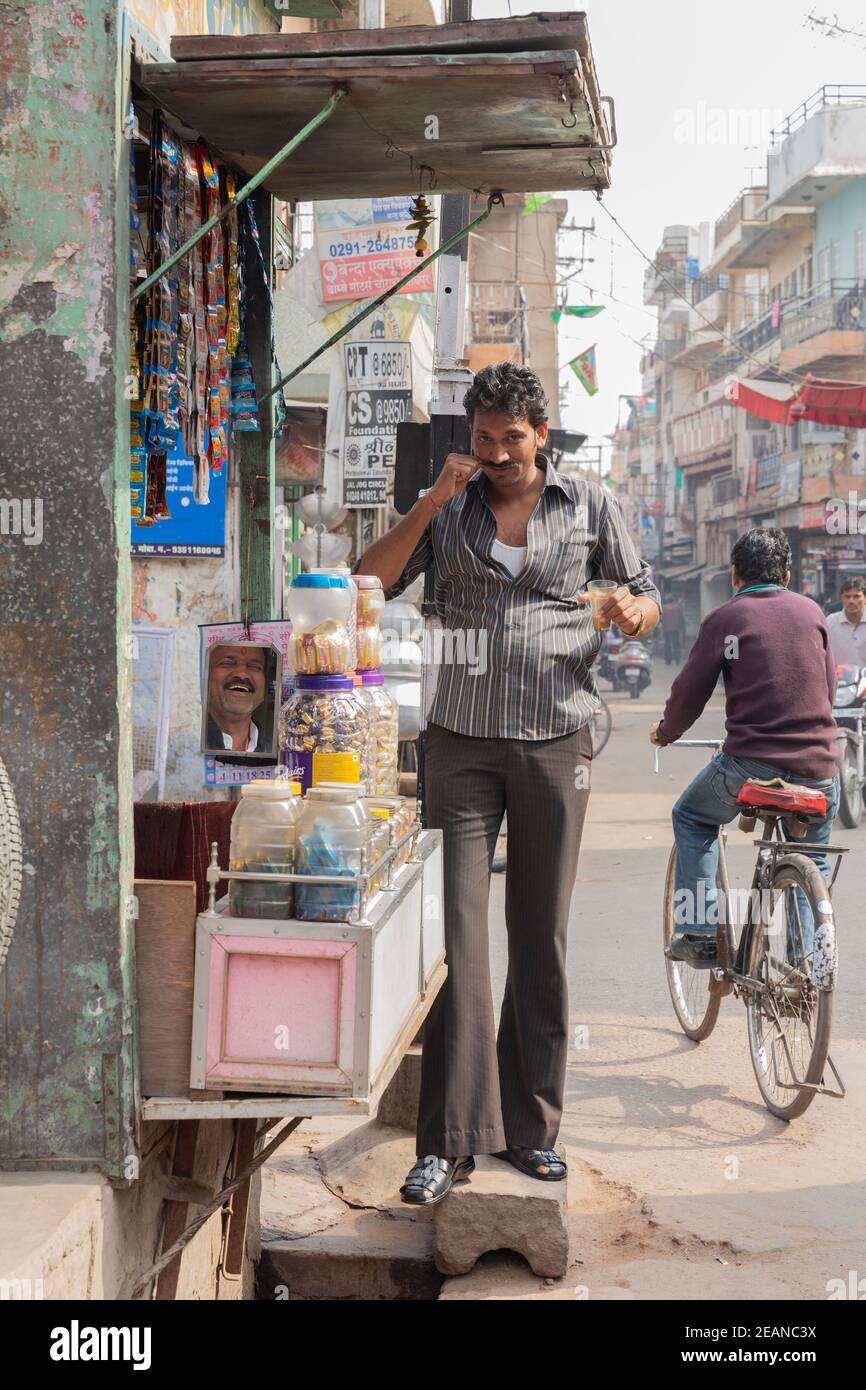 Jodhpur India Man enjoys a glass of chai tea, chatting with the owner ...