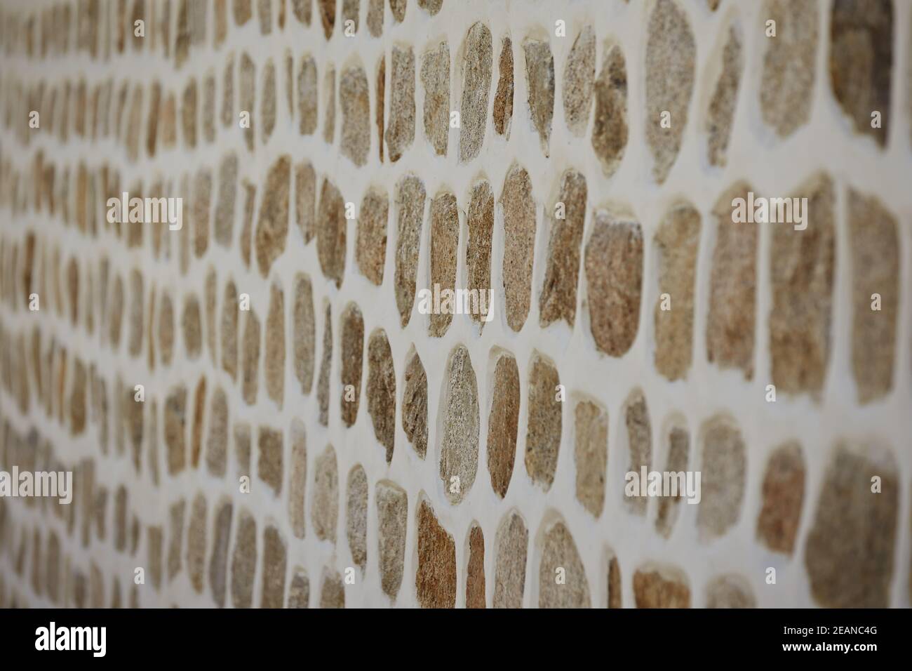 Blurry shot of a natural brown stone wall background Stock Photo - Alamy