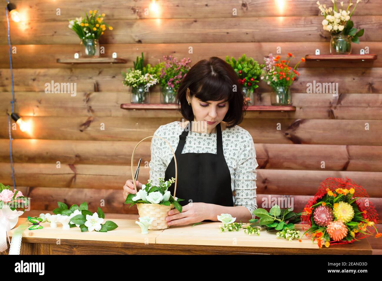 Workplace of a florist decorator Woman collecting bouquet Stock Photo ...