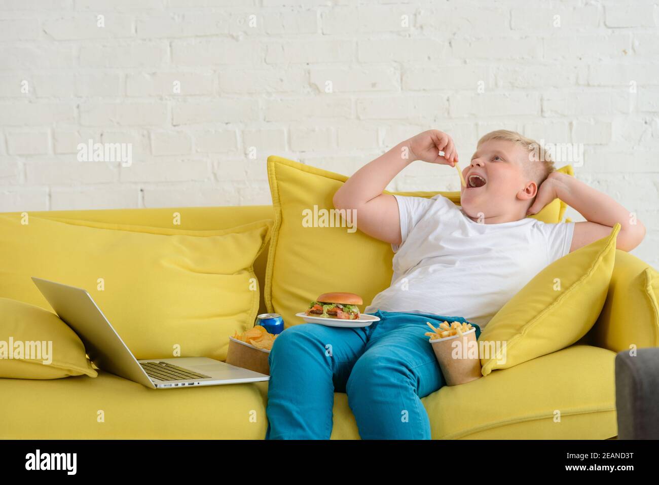 Fat child eating chips hi-res stock photography and images - Alamy