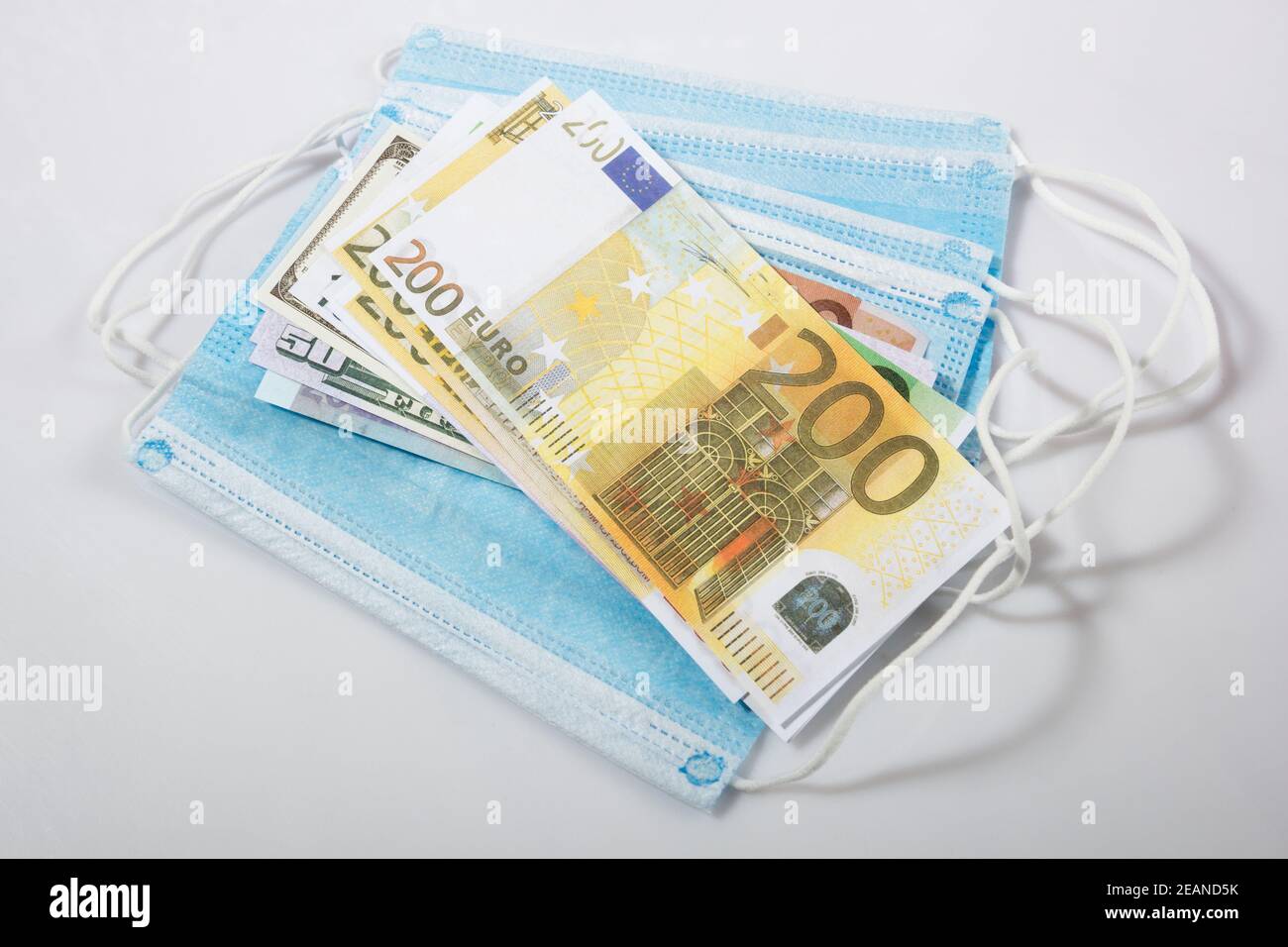 euro banknotes and disposable hygienic mask Stock Photo - Alamy
