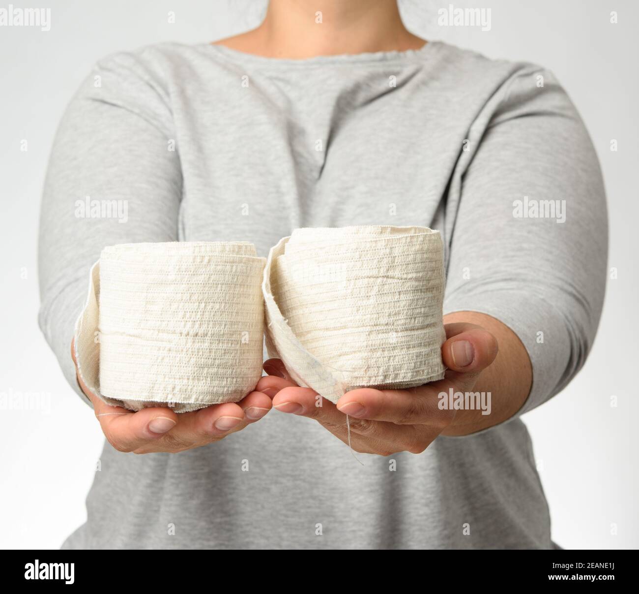 woman holds in hand a white elastic bandage for the body Stock Photo ...