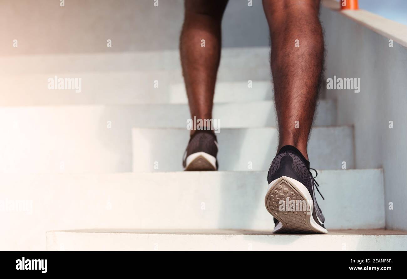 sport runner black man step running up to climbing stairs Stock Photo ...