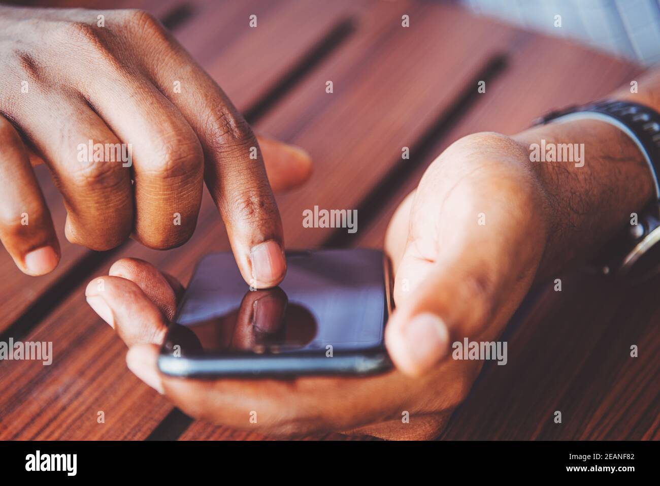 man person holding a modern smart phone and touching a finger to blank ...