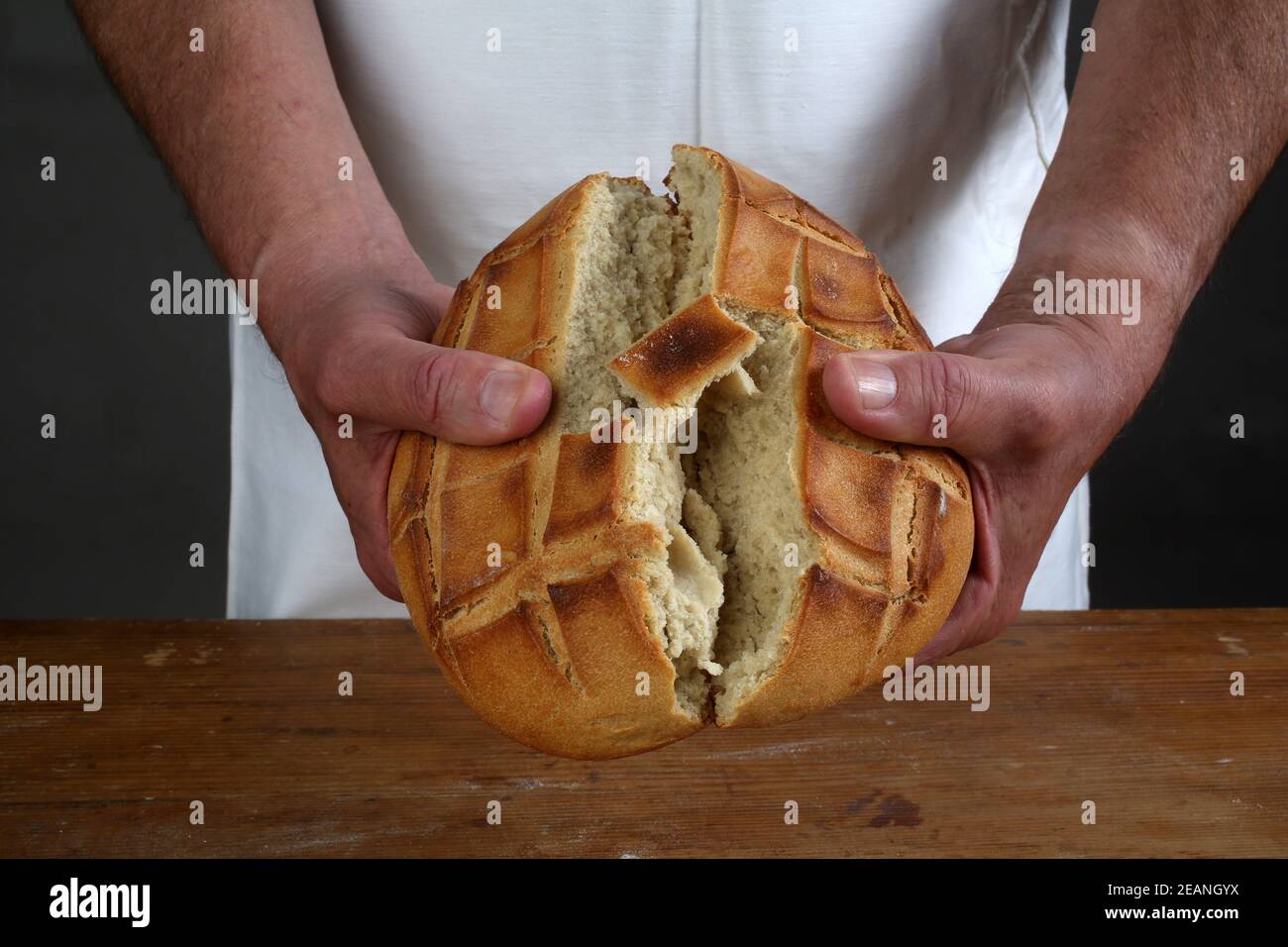 Man breaking a loaf of bread hi-res stock photography and images - Alamy