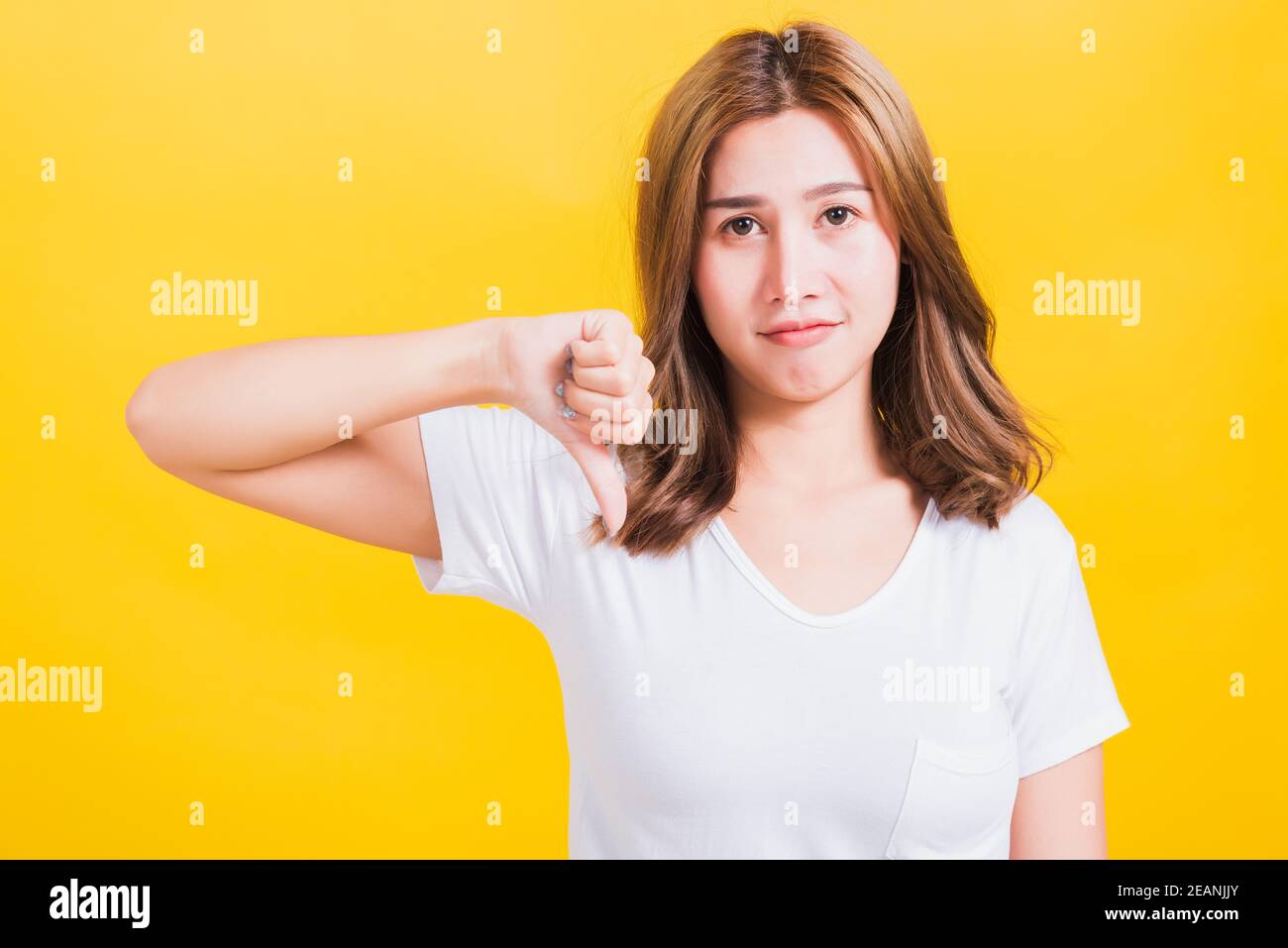 woman unhappy, a negative gesture showing finger thumbs down Stock ...