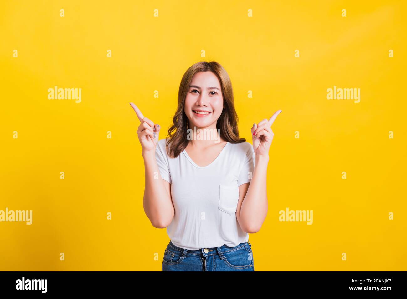 woman teen standing makes gesture two fingers point upwards above Stock ...