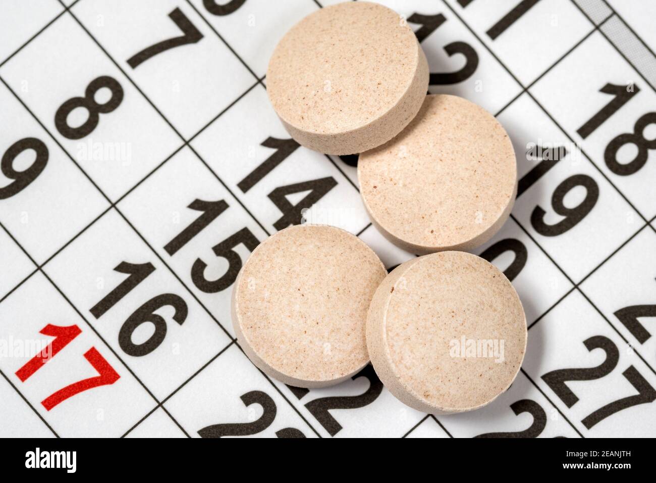 Close up of medical pills on a calendar. Medication plan, schedule ...