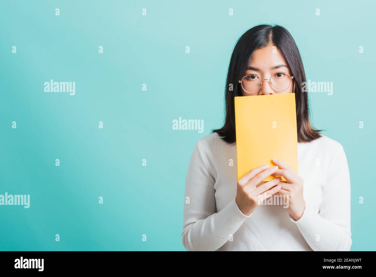 woman hiding behind an open book Stock Photo - Alamy