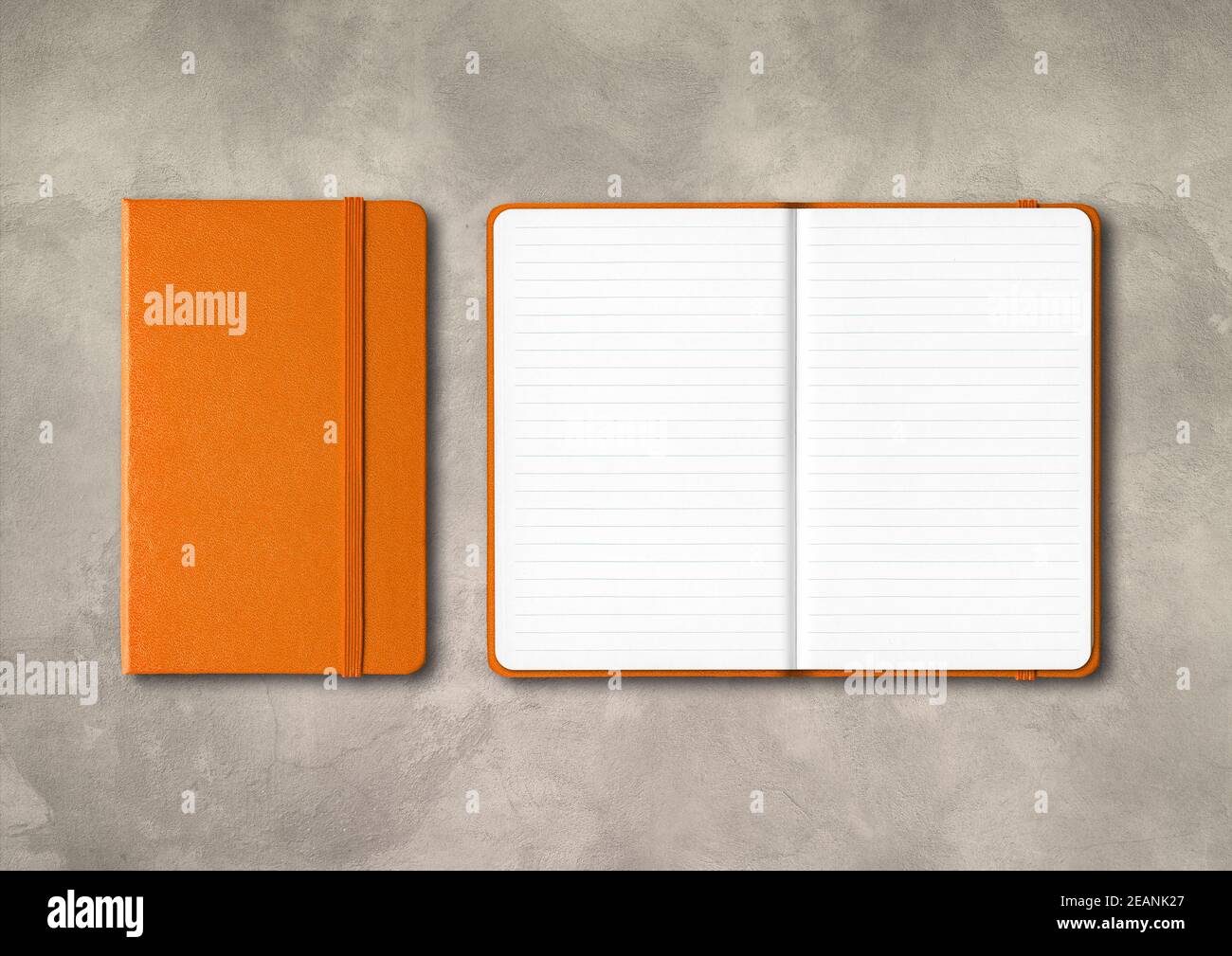 Orange closed and open lined notebooks on concrete background Stock ...