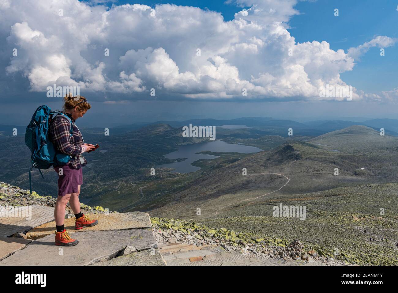 Hiker looking at the scenery around Gausta (Gaustatoppen), highest ...