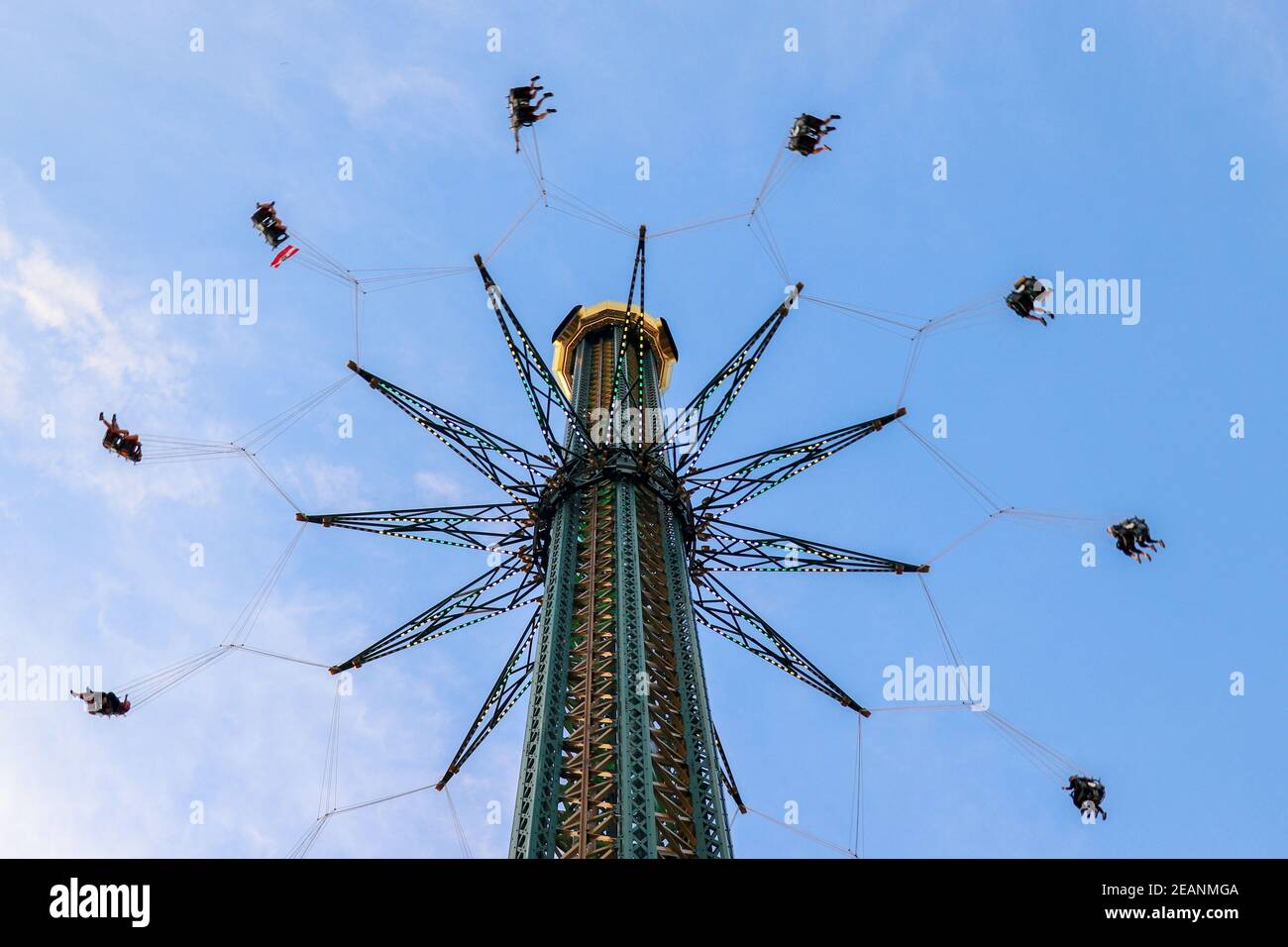 Low angle shot of wheel amusement park , swing ride at fair spinning ...