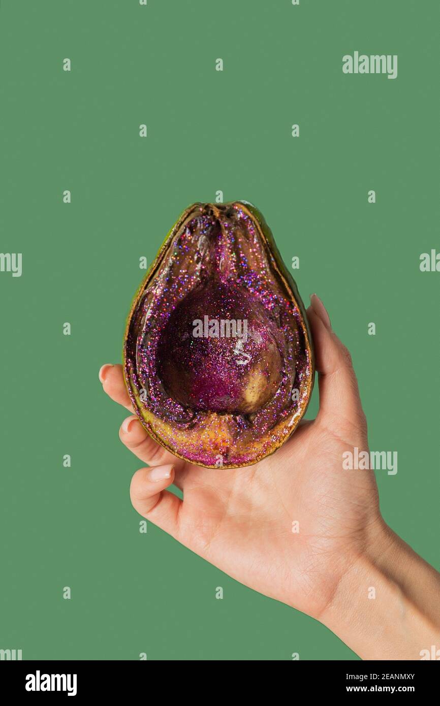 Colored avocado on a green background.Added glitter. Fun, minimal and ...