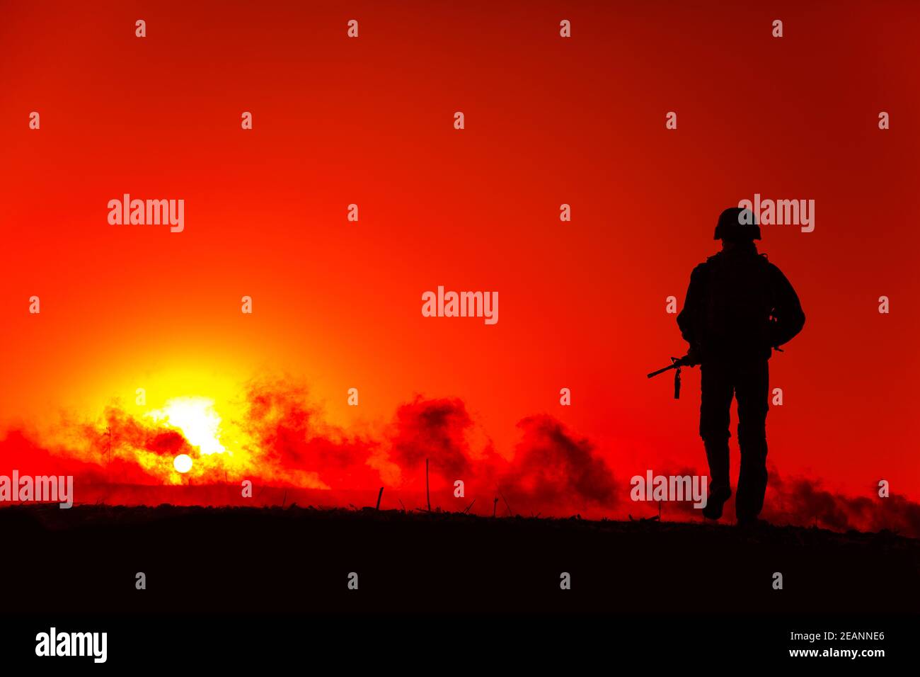 Army soldier walking on battlefield at sunset Stock Photo - Alamy