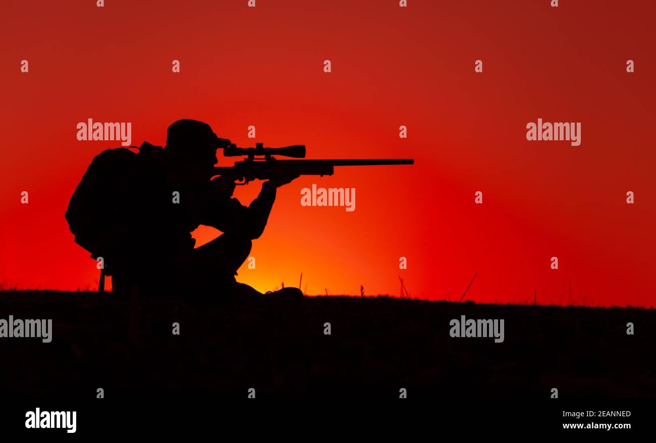 Commando sniper aiming, shooting rifle on seacoast Stock Photo - Alamy