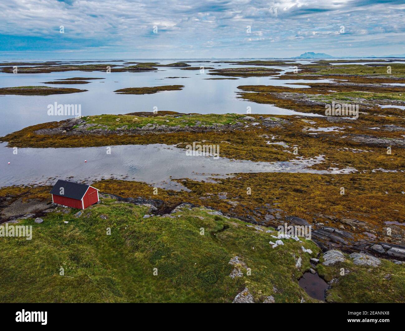 Aerial of a red boat shed on the rugged coastline of the UNESCO World ...