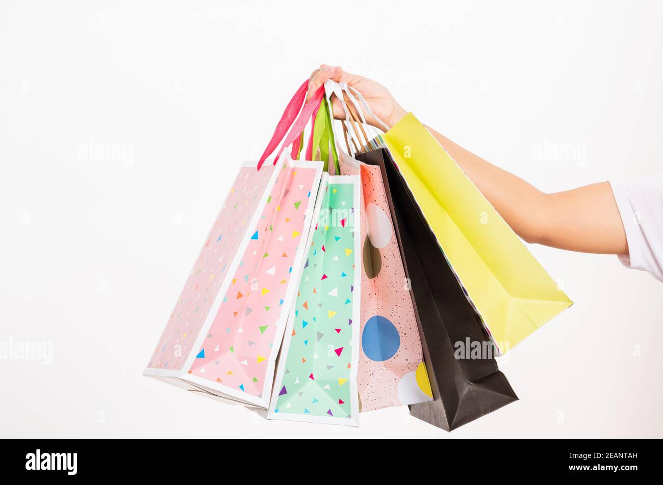 women hand holding colorful multicolor shopping bag many packets Stock ...