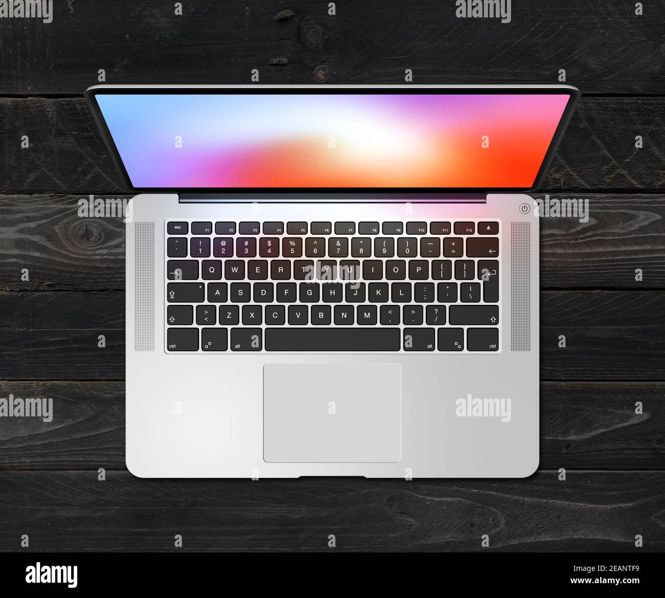 Open laptop top view with colorful screen, isolated on black wood ...