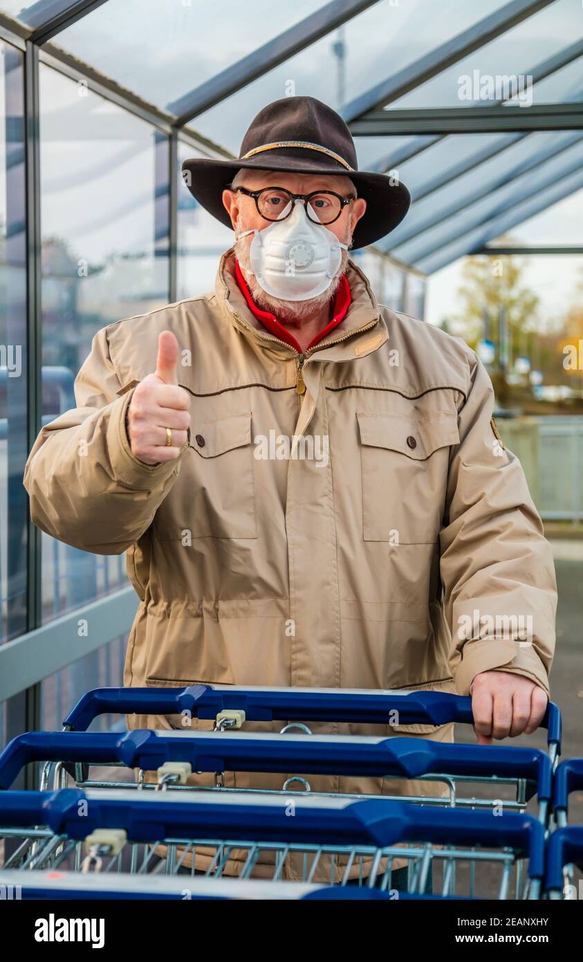 Senior Man makes thumbs up with Trolley Carts Stock Photo - Alamy