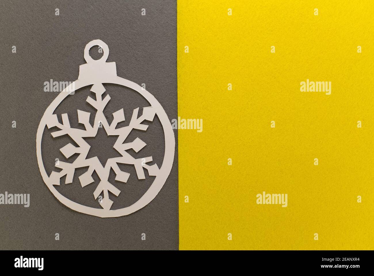 Paper cut Christmas ball on grey yellow background Stock Photo - Alamy