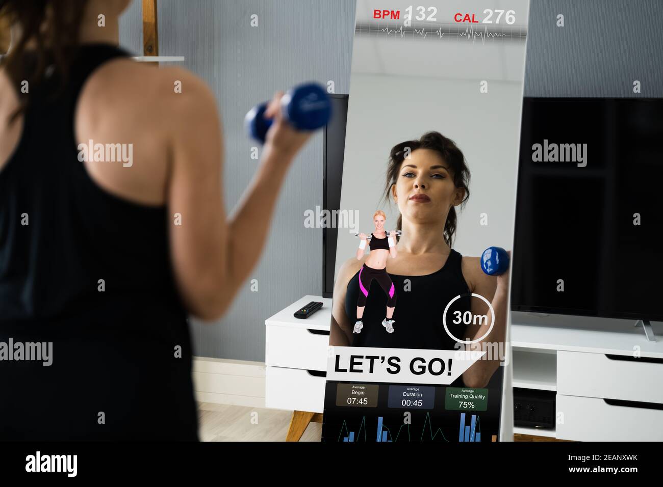 Fitness Exercise At Home Using Smart Mirror Stock Photo - Alamy
