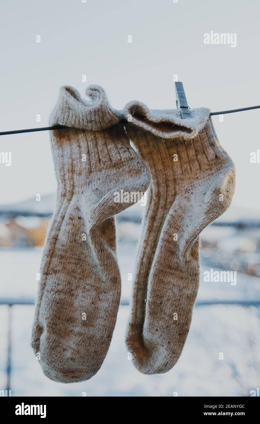 Clean woolen socks are put on the street in the courtyard of a village ...