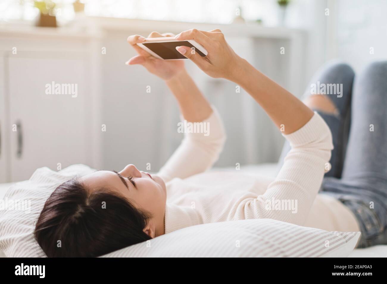 Female watching mobile hi-res stock photography and images - Alamy