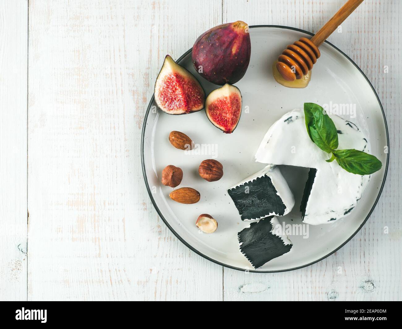 Unusual black camembert cheese with white mildew Stock Photo - Alamy