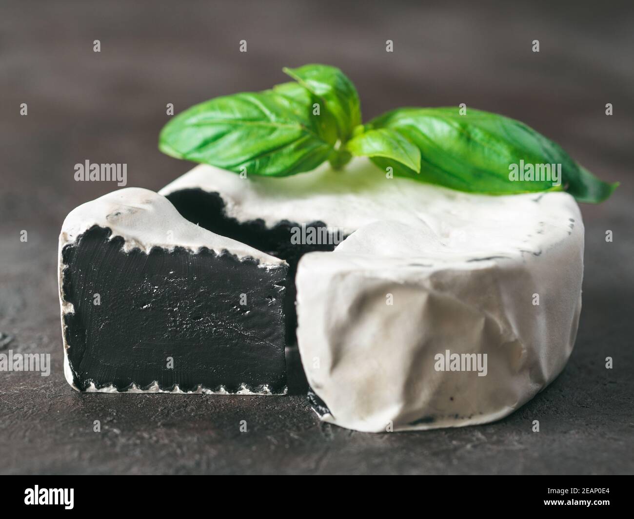 Unusual black camembert cheese with white mildew Stock Photo - Alamy