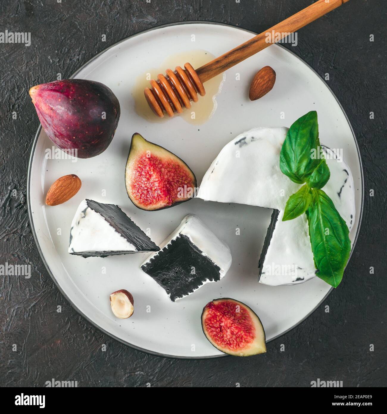 Unusual black camembert cheese with white mildew Stock Photo - Alamy