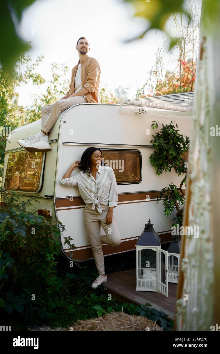 Happy couple poses near rv, camping in a trailer Stock Photo - Alamy