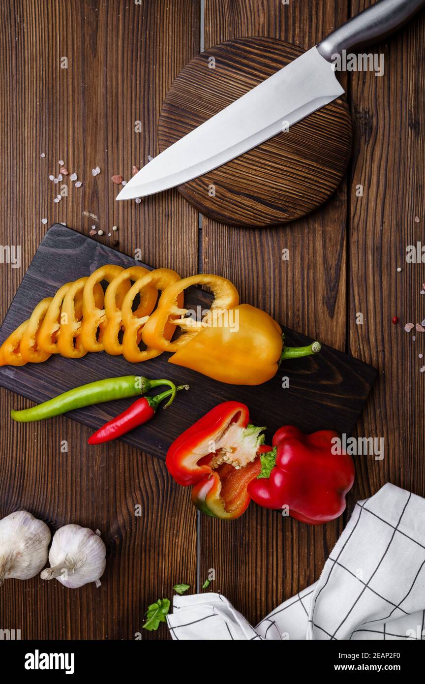 Fresh cutted pepper on board, top view Stock Photo - Alamy