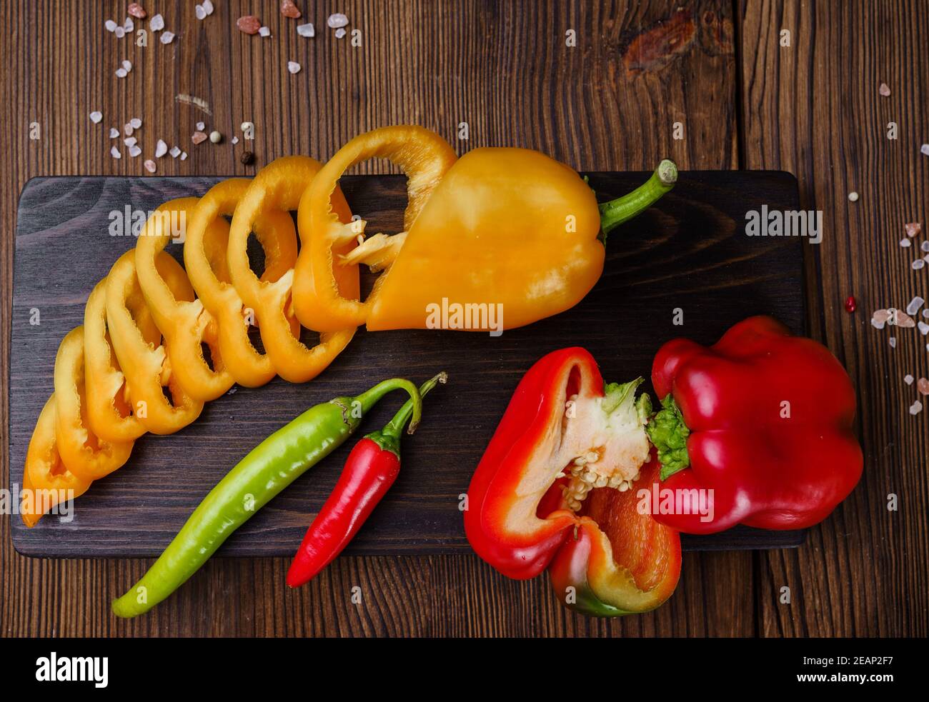 Fresh cutted pepper on board, top view Stock Photo - Alamy