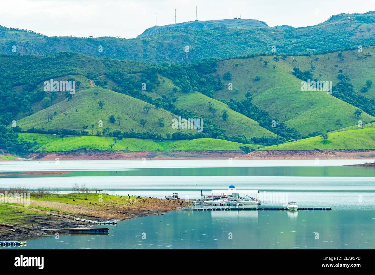 Beautiful lake landscape next to the mountains and a boat deck. Photo ...