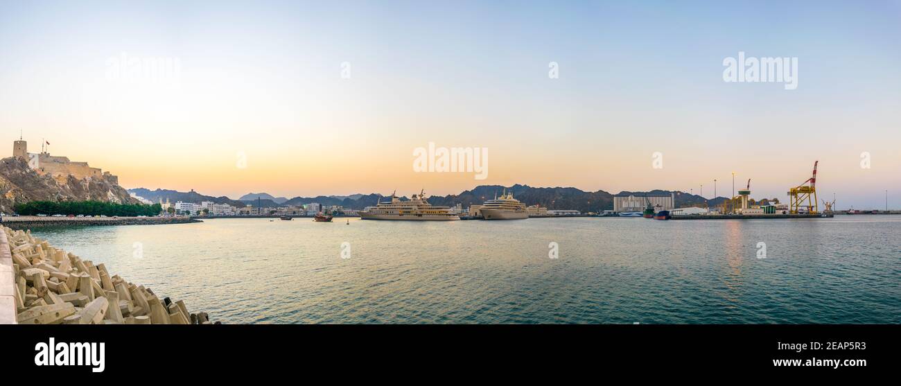 View of coastline of Muttrah district of Muscat during sunset, Oman ...