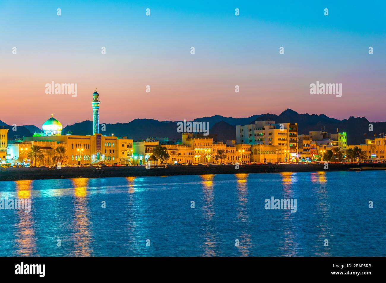 View of coastline of Muttrah district of Muscat during sunset, Oman ...