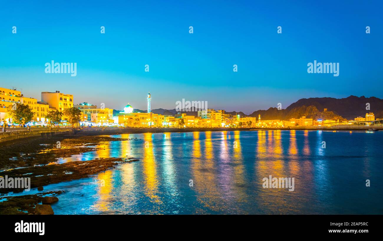 View of coastline of Muttrah district of Muscat during sunset, Oman ...