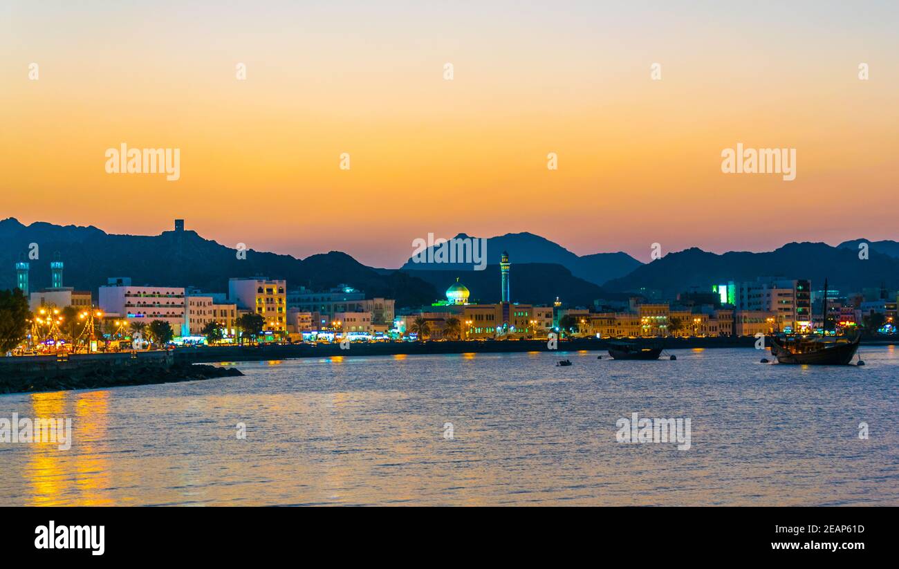 View of coastline of Muttrah district of Muscat during sunset, Oman ...