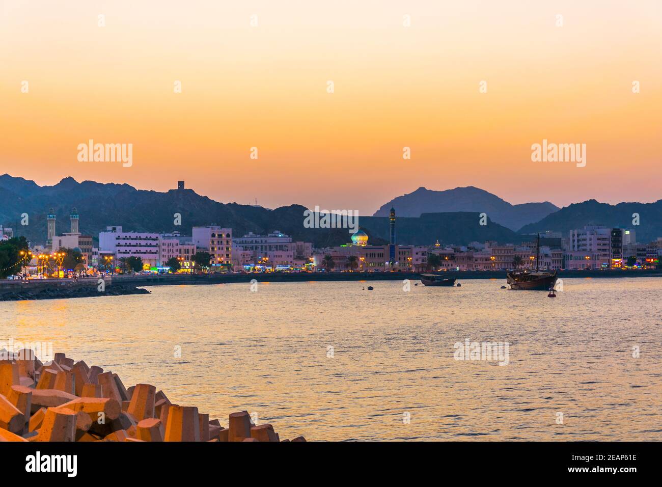View of coastline of Muttrah district of Muscat during sunset, Oman ...